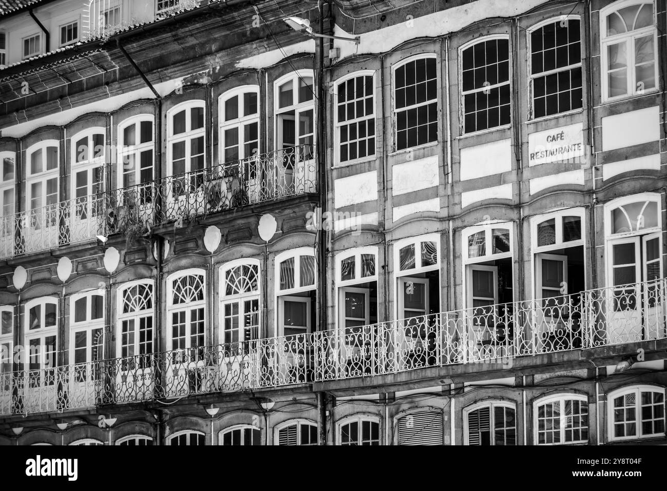 Traditional Portuguese facade with many windows at a house at Largo do ...