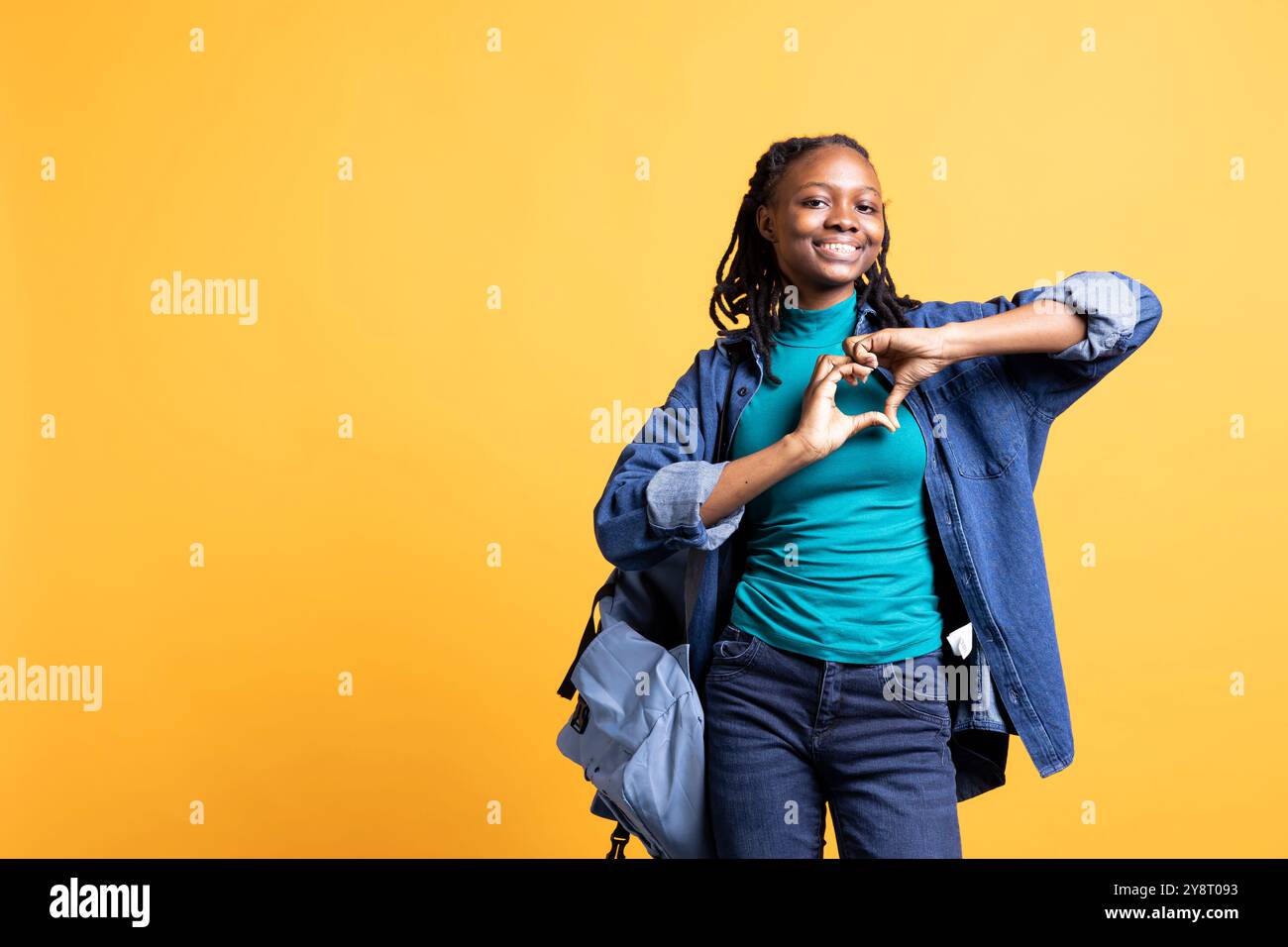 Portrait of loving cheerful african american teenager doing heart ...
