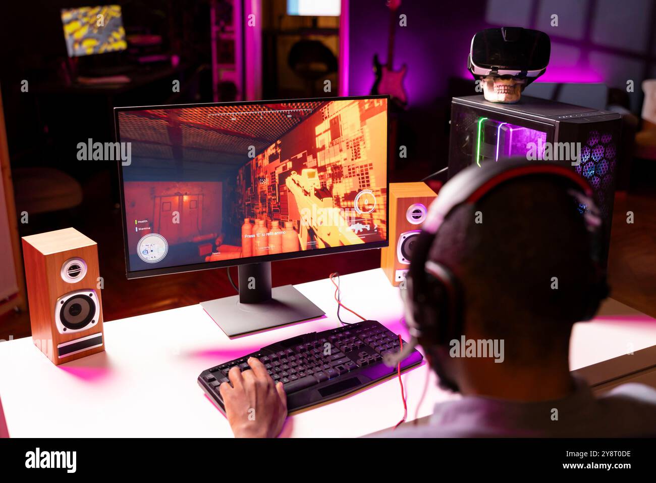 Man playing science fiction FPS videogame, having fun in dark apartment ...