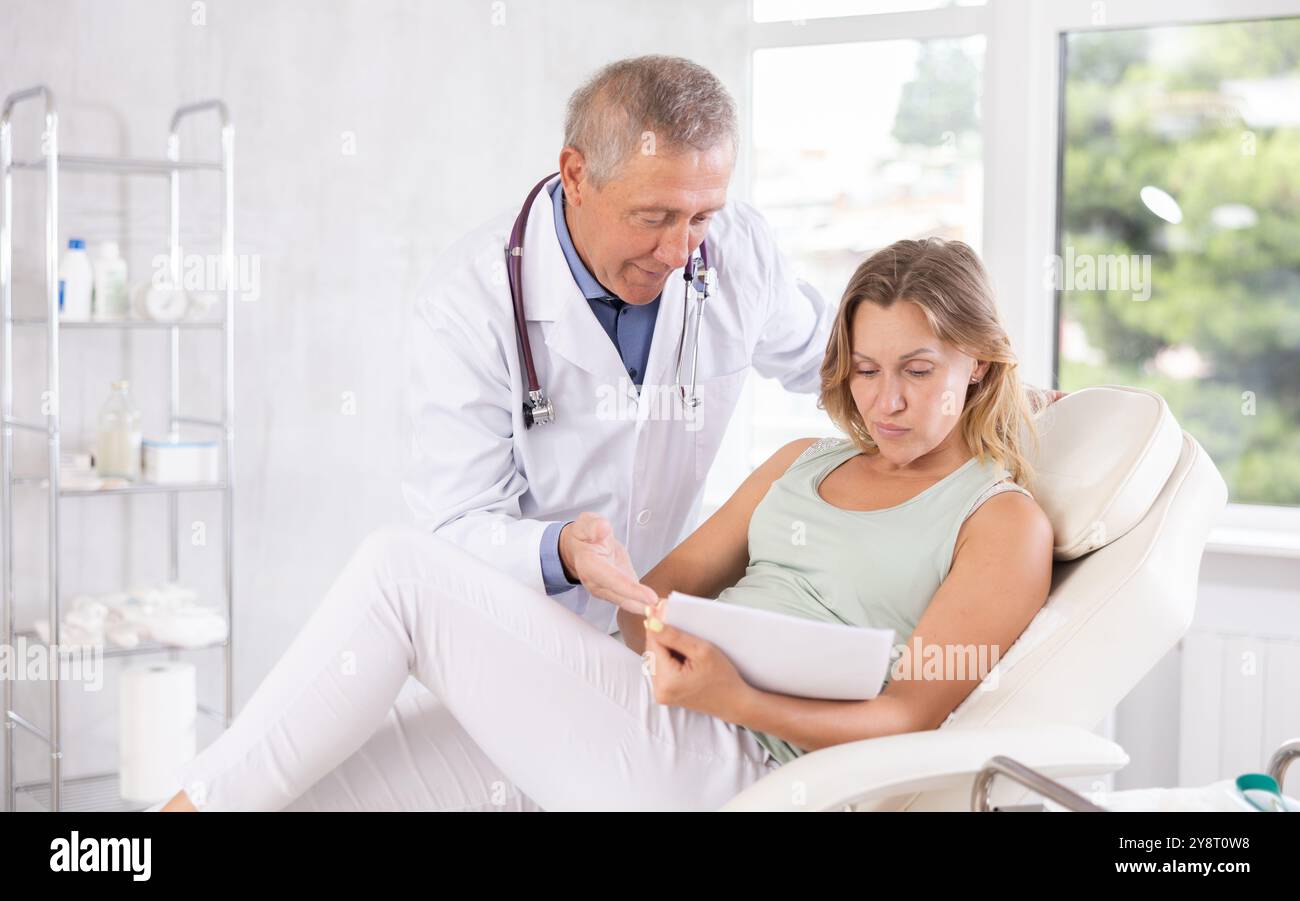 Man doctor give female patient medical documents for review before ...