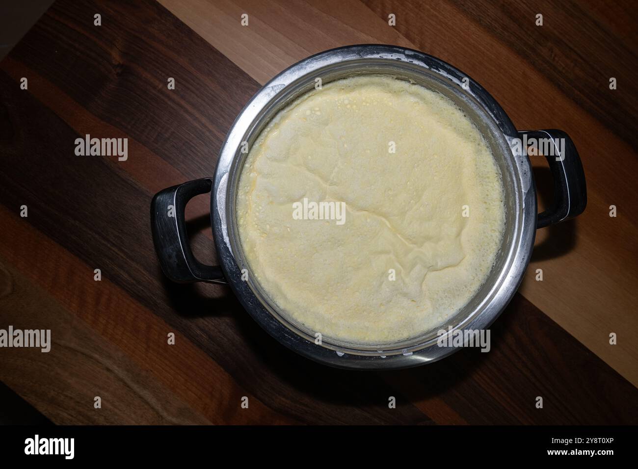 A layer of cream formed on milk boiled in a saucepan Stock Photo - Alamy