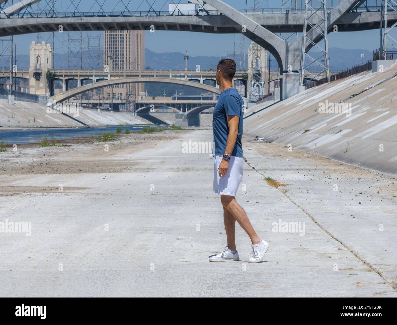 Person in Los Angeles River Channel with Iconic Bridges and Mountains ...