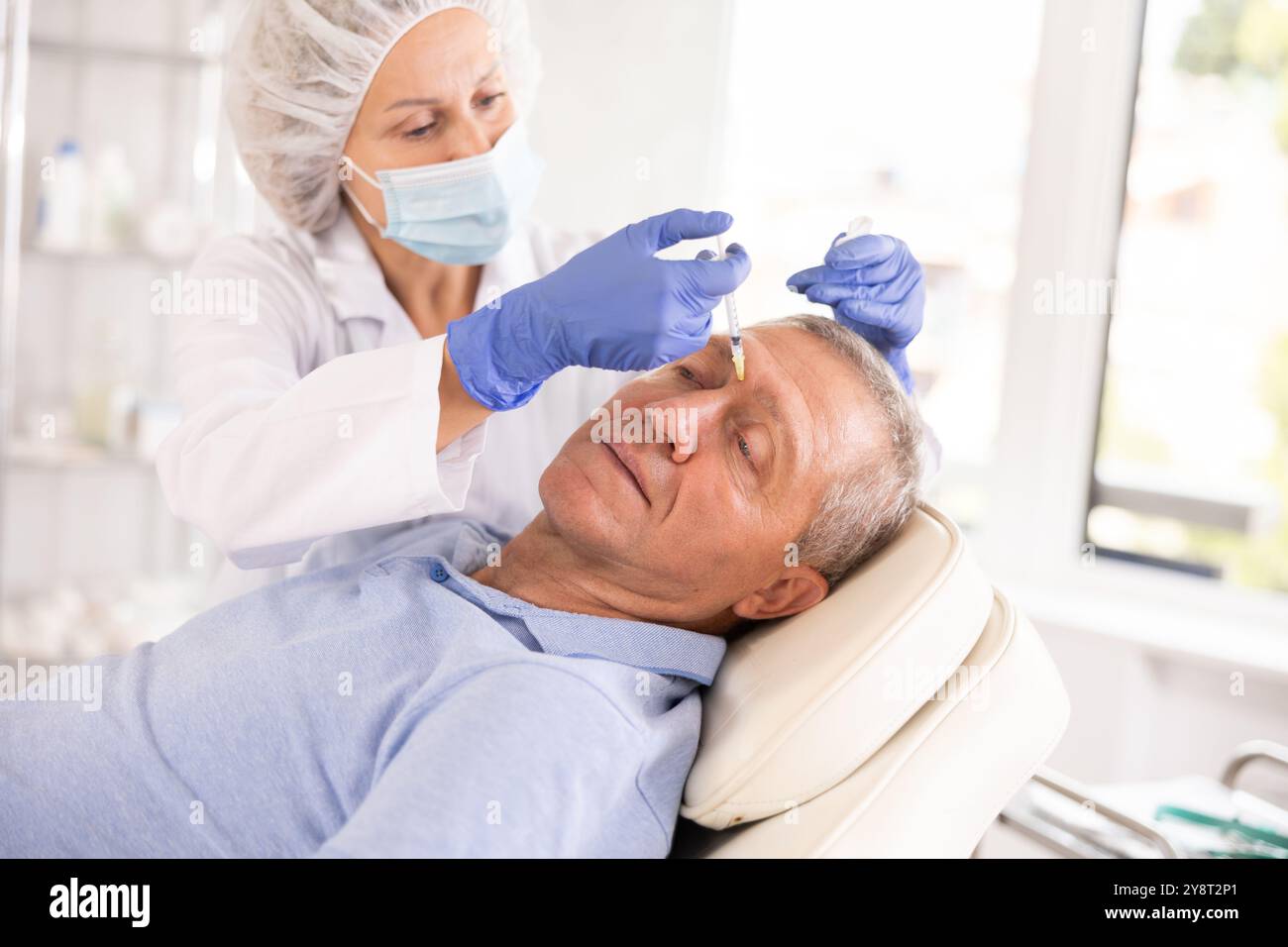 Doctor performs procedure of injectable correction of wrinkles in nasal ...