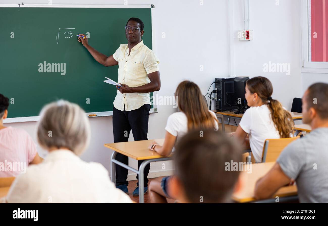 Confident african american professor giving lecture to group of ...