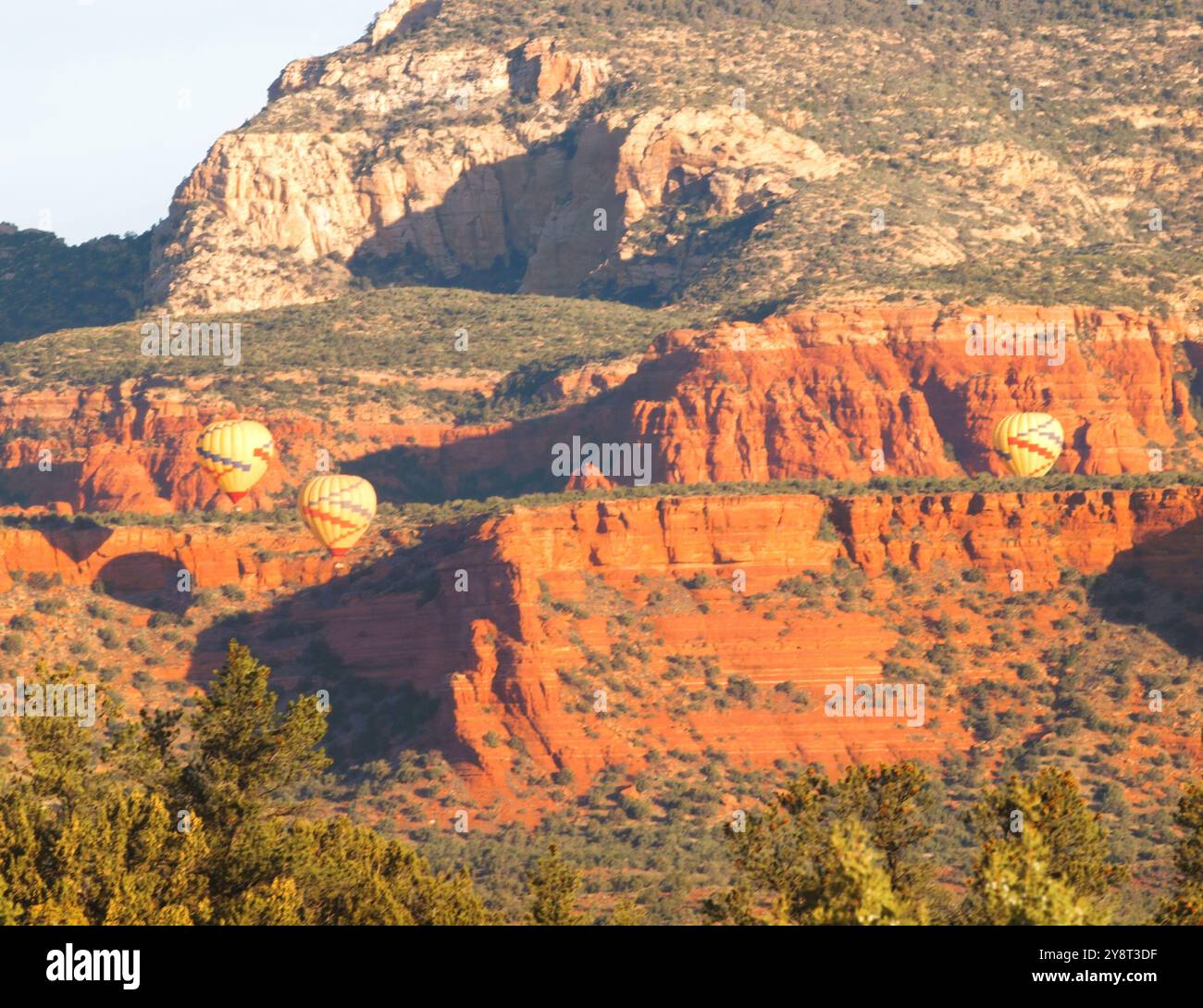 Three hot air balloons and red rocks Stock Photo - Alamy