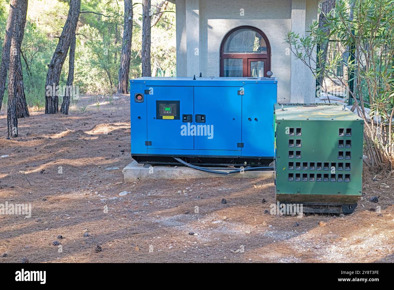 Blue and green coloured generators installed in a plant. Alternative ...