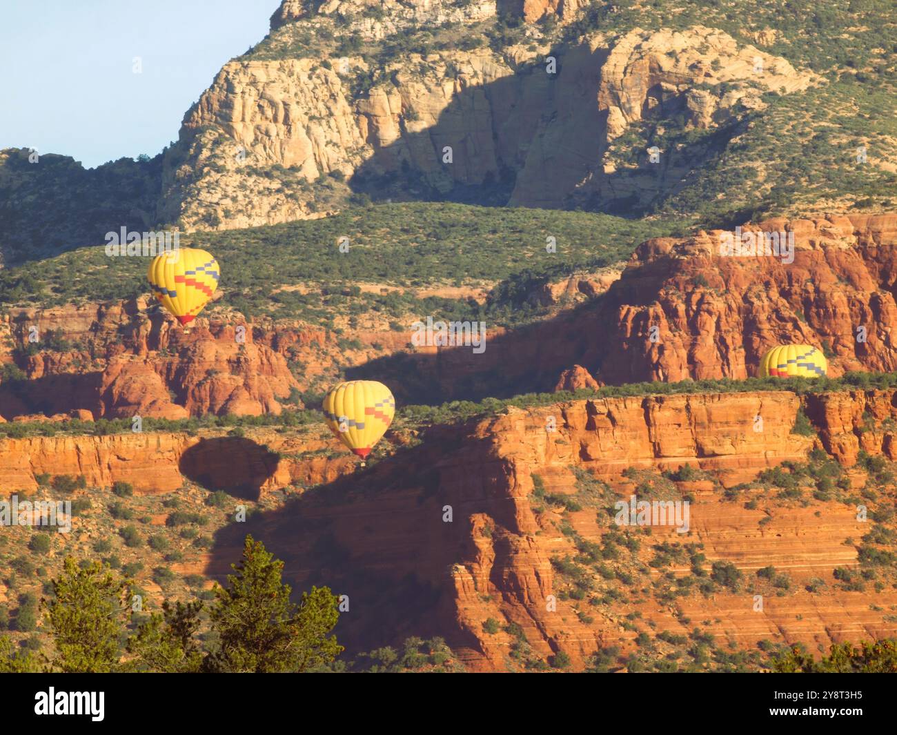 Three hot air balloons and red rocks Stock Photo - Alamy