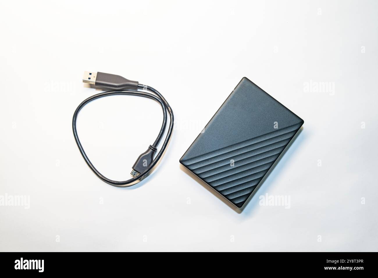 Digital storage device and cable in black on a white background Stock ...