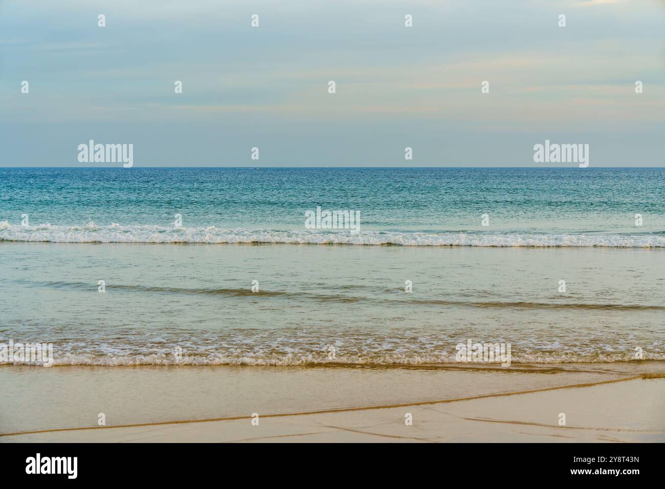 Waves rolling onto beach sunset hi-res stock photography and images - Alamy