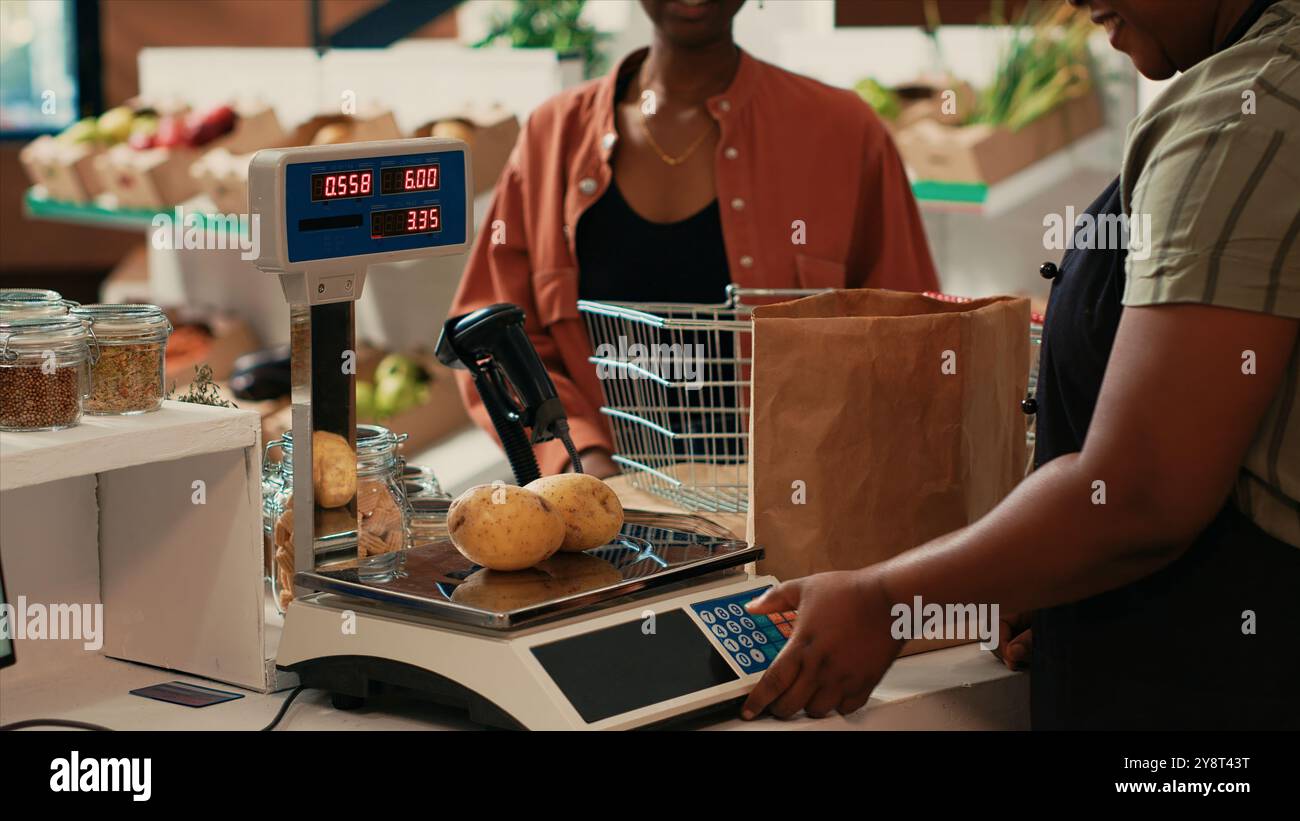 Grocery store owner weighting fruits and vegetables on scale to sell ...