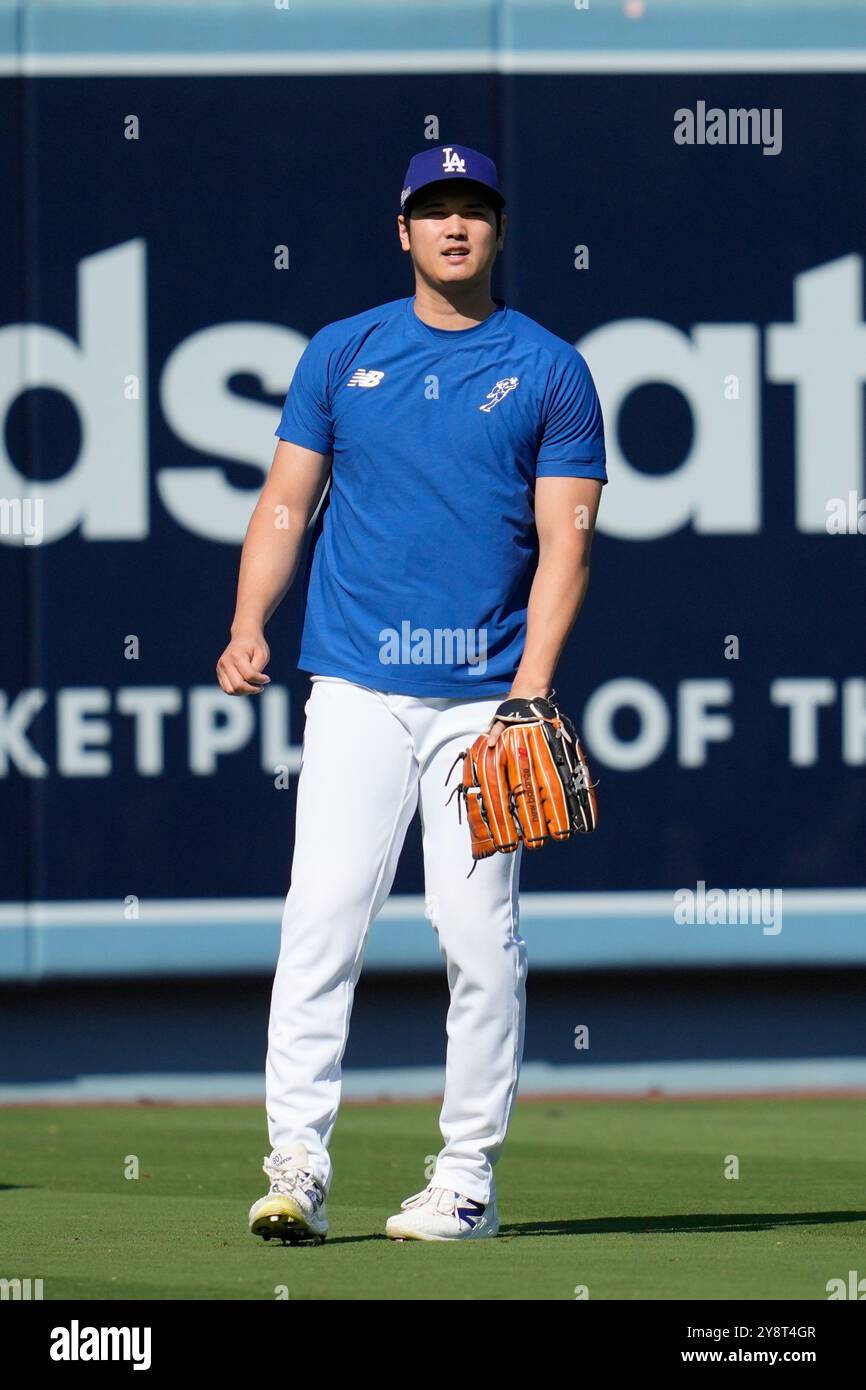Los Angeles Dodgers' Shohei Ohtani works out in the outfield before ...