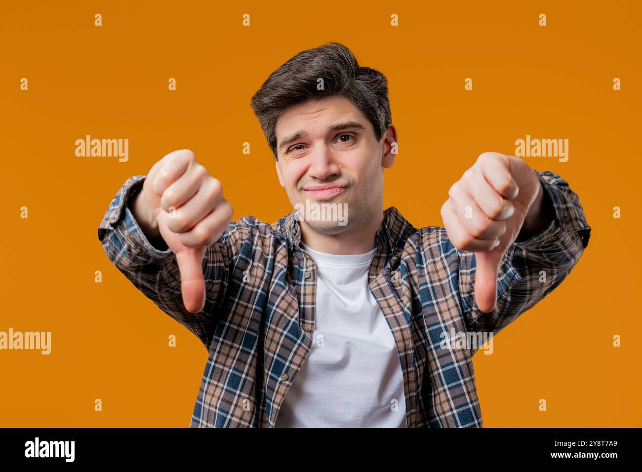 Adult 30s man with sign of dislike. European guy expressing thumbs-down ...