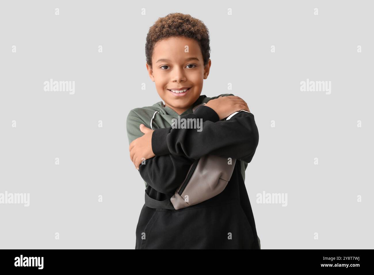 Little African-American boy hugging himself on white background Stock ...