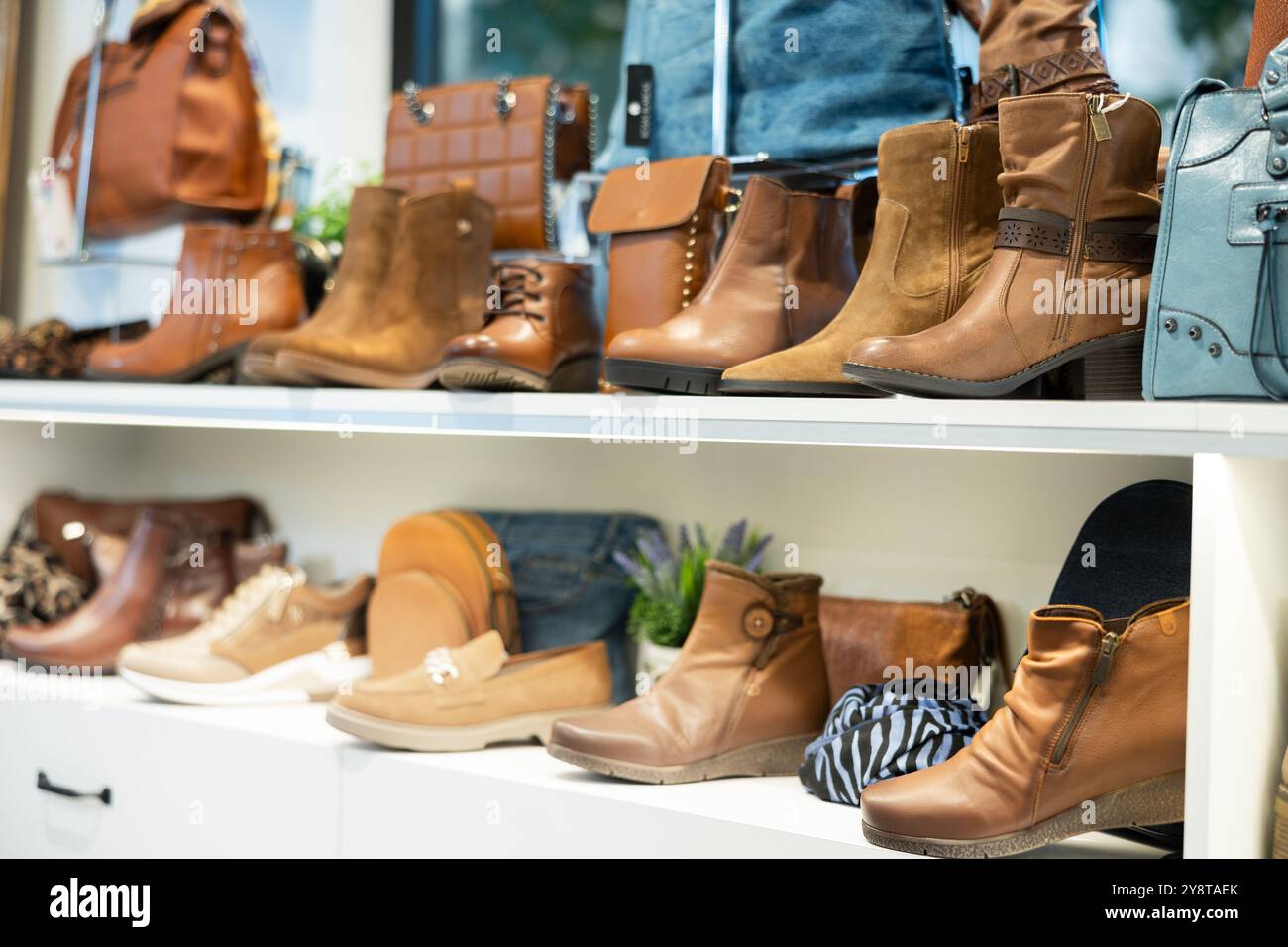 Women's boots displayed on counter in store Stock Photo - Alamy