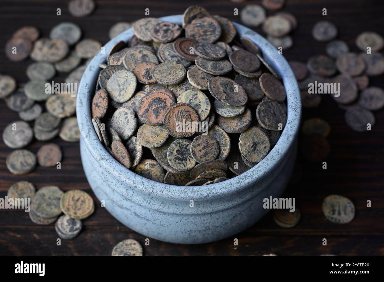 Roman coin hoard on dark wooden table, lot of Ancient money in old ...