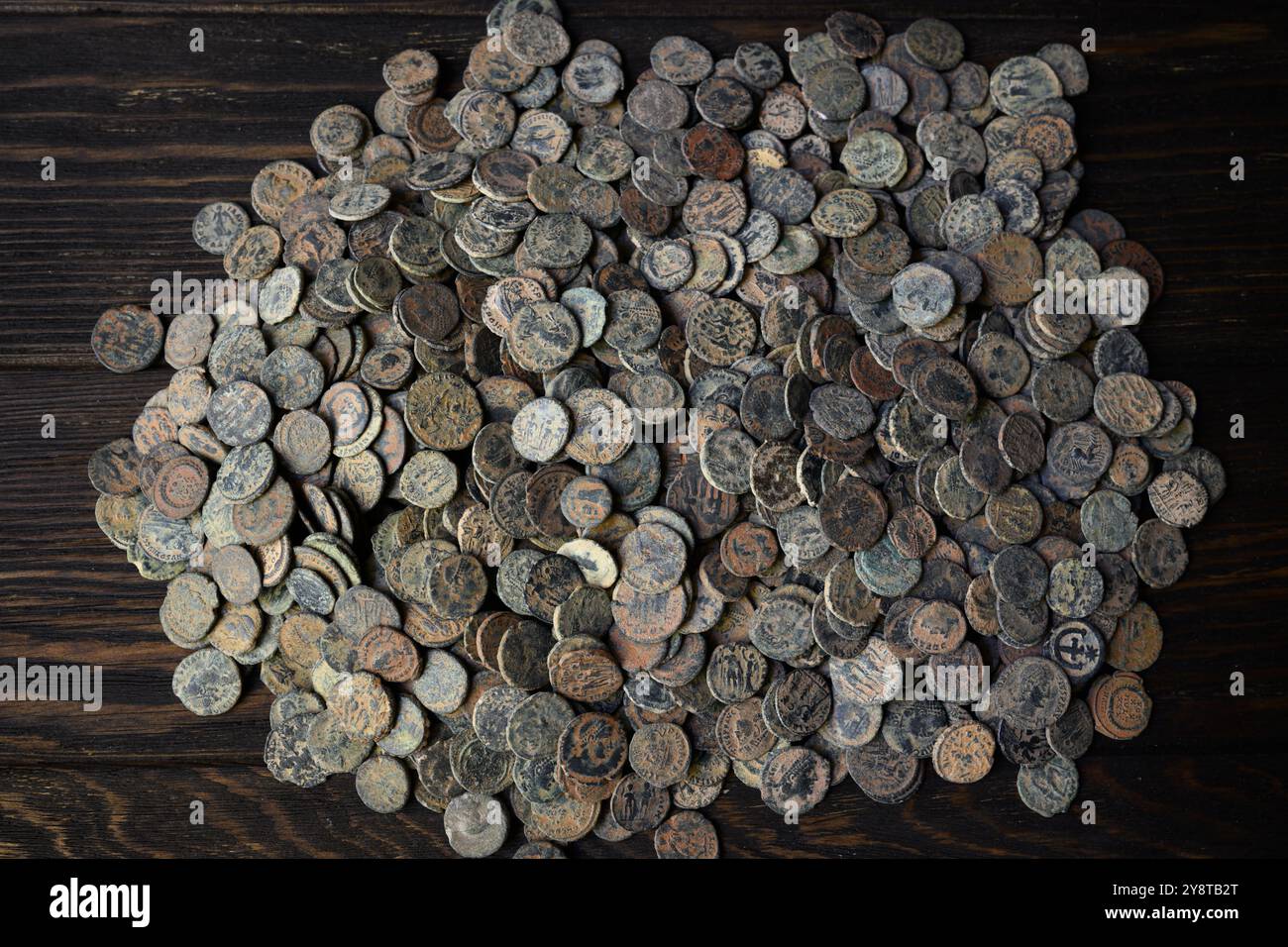 Lot of Ancient Roman coins on dark wooden table, top view of pile of ...