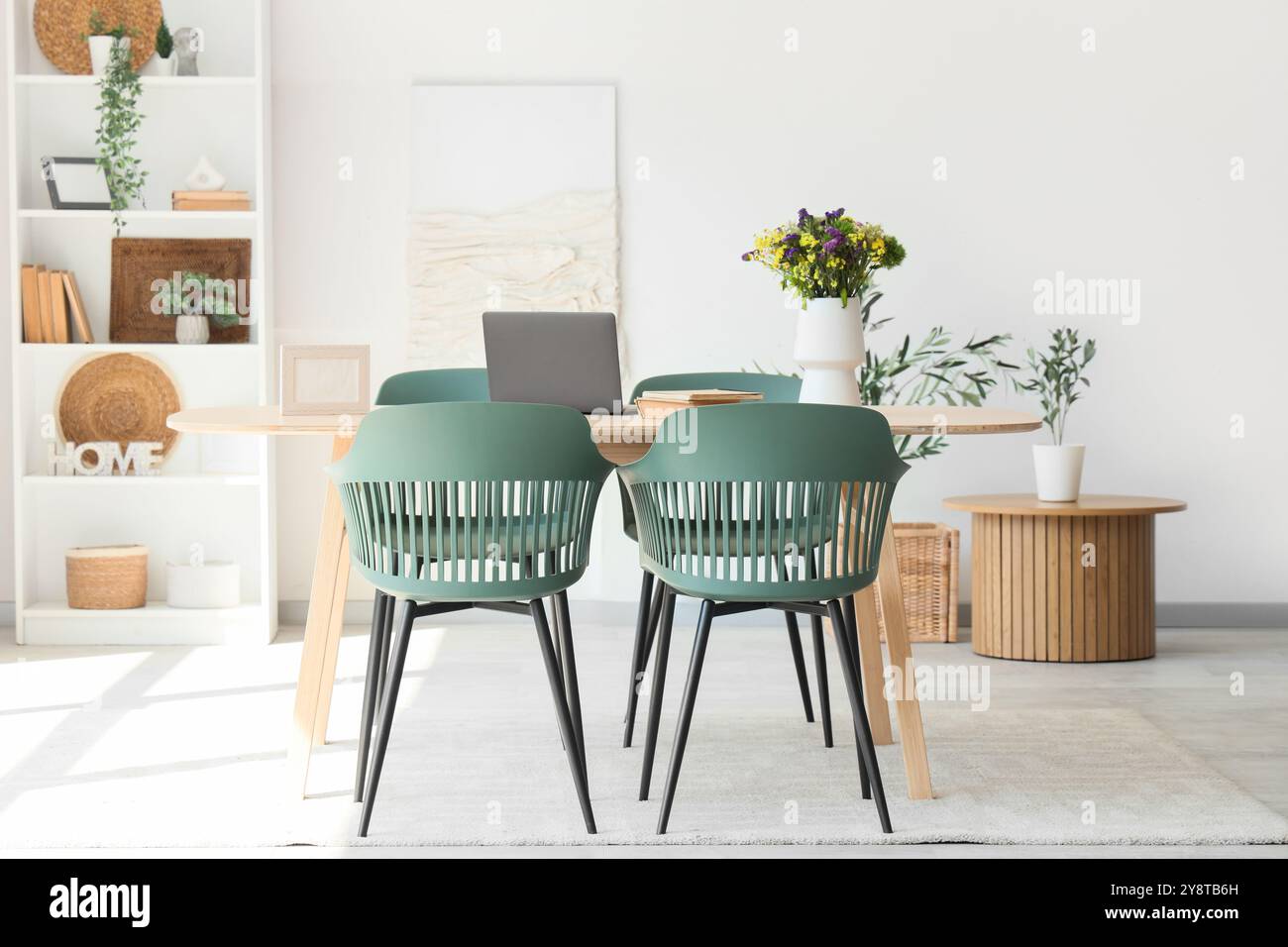 Interior of dining room with table and shelf unit Stock Photo - Alamy