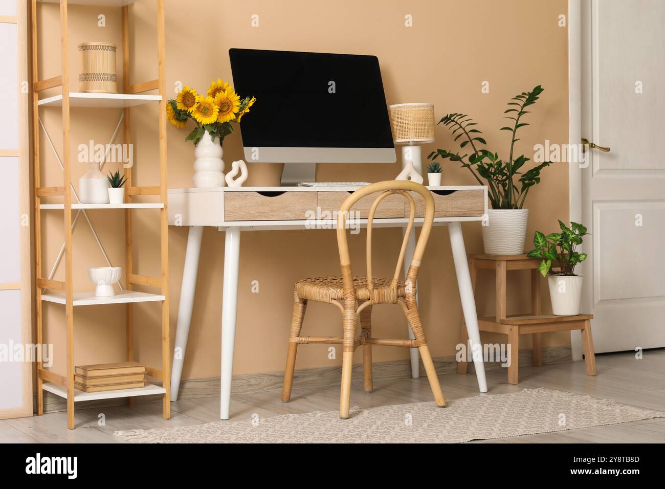 Interior of office with workplace, shelf unit and plants Stock Photo ...