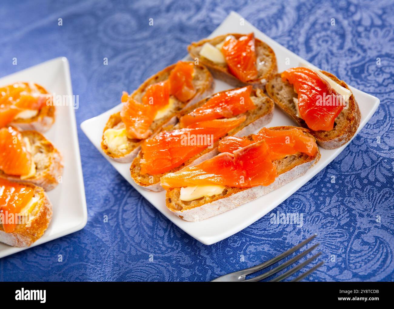 canapes with delicate butter and pieces of bright pink salmon Stock ...