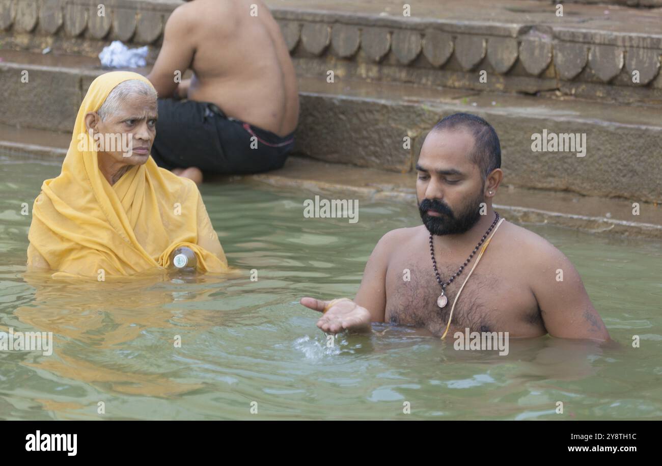 Pilgrims at ghat steps on river Ganges, Varanasi, Uttar Pradesh, India ...
