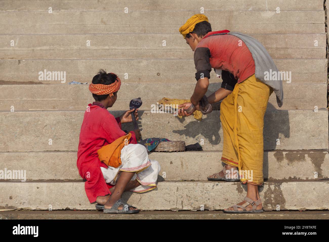 Children with cobras at ghat steps on river Ganges, Varanasi, Uttar ...