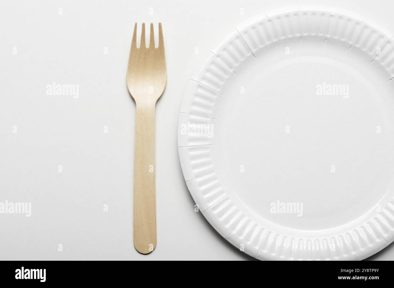 Wooden single use kitchenware and paper plate on white background ...