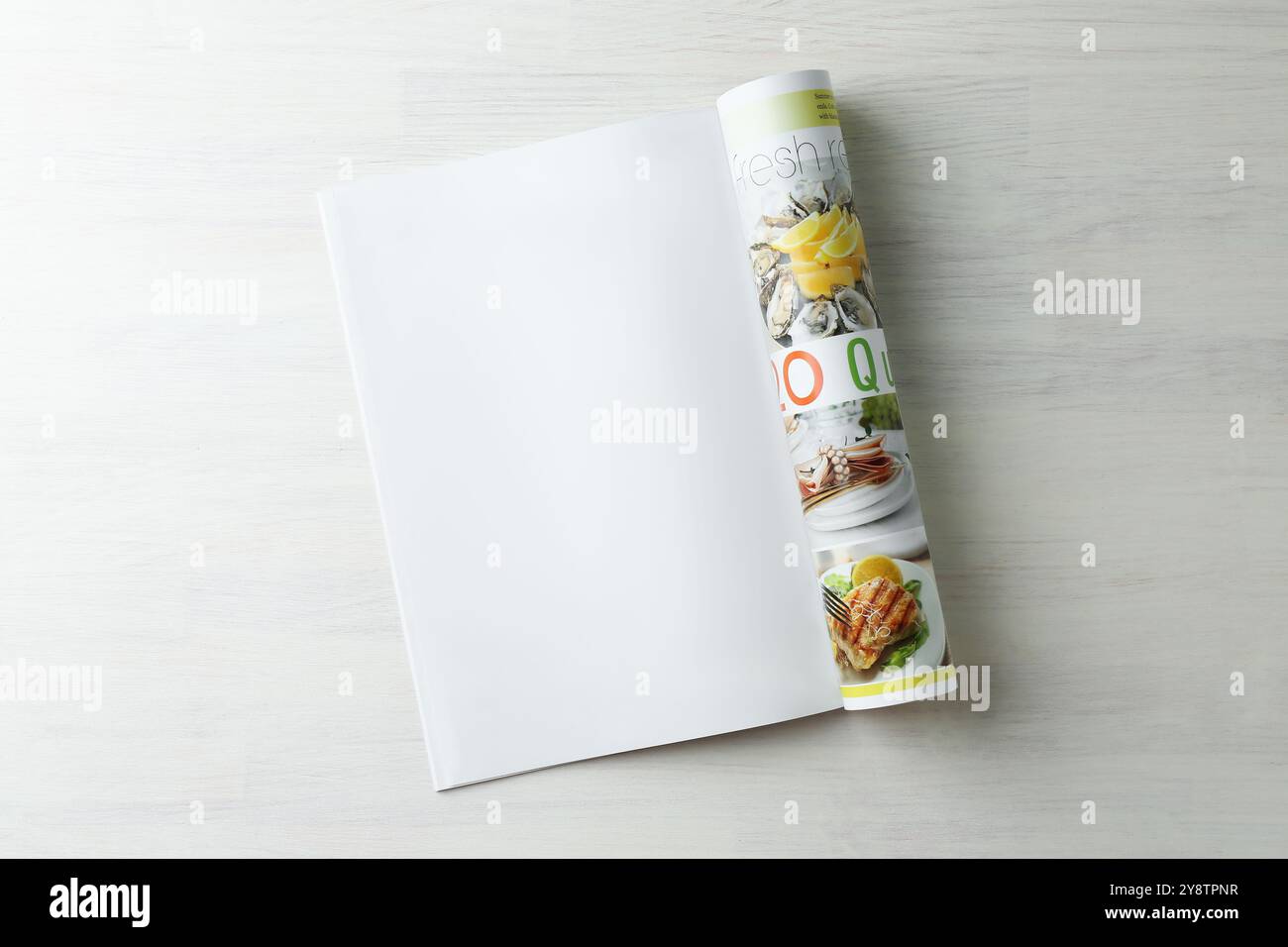 Open magazine on white wooden table, top view. Mockup for design Stock ...