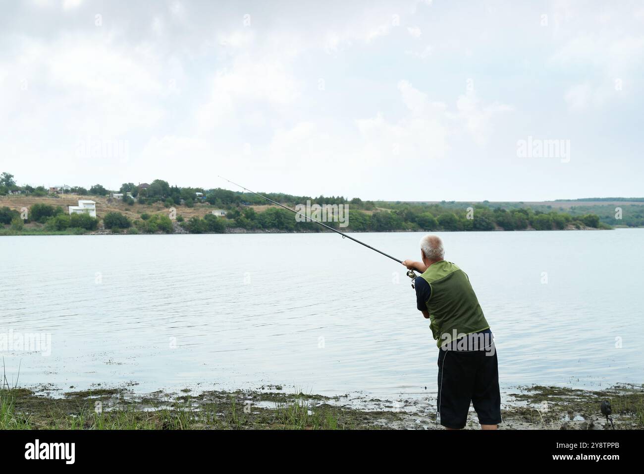 Back view man holding fishing hi-res stock photography and images - Alamy