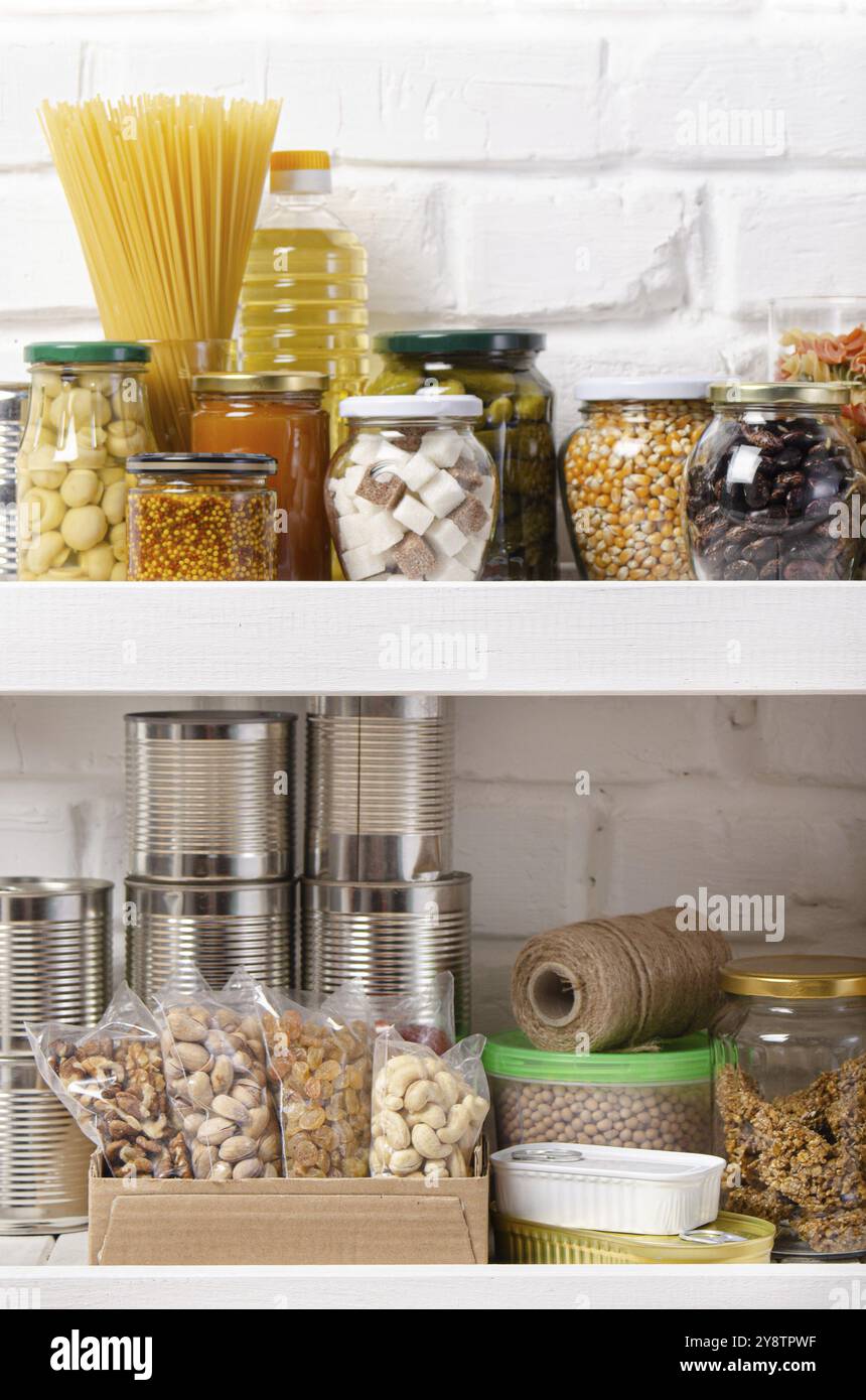 Set of non-perishable foods on pantry shelf on brick wall background ...