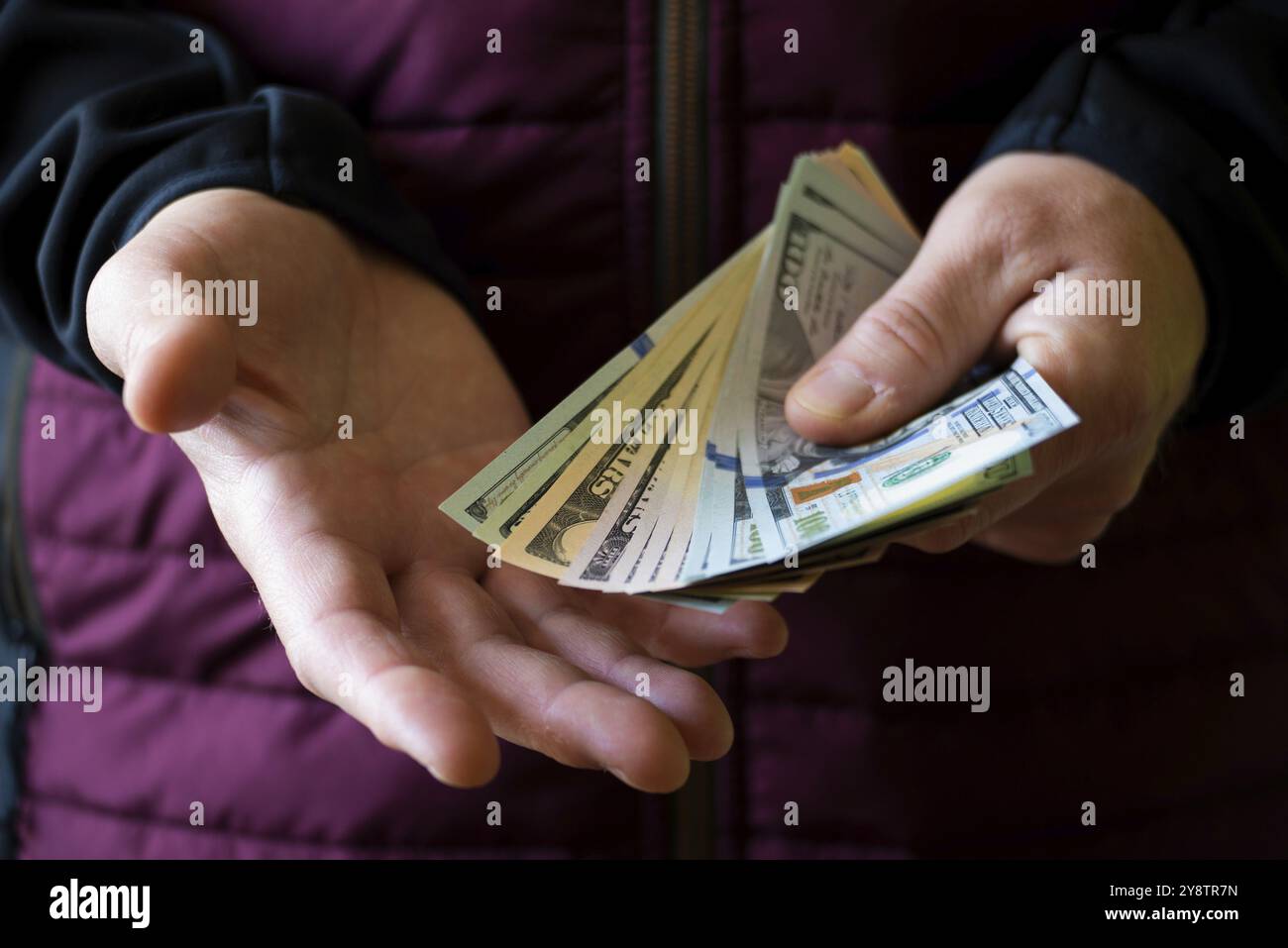 White male shows dollar bills in his hand closeup front view Stock ...