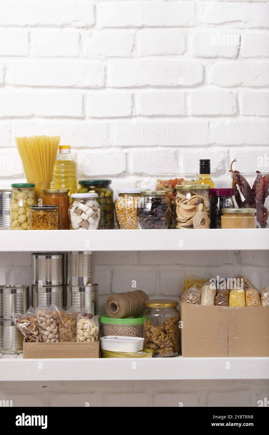 Set of long storage term foods on pantry shelf prepared for disaster ...