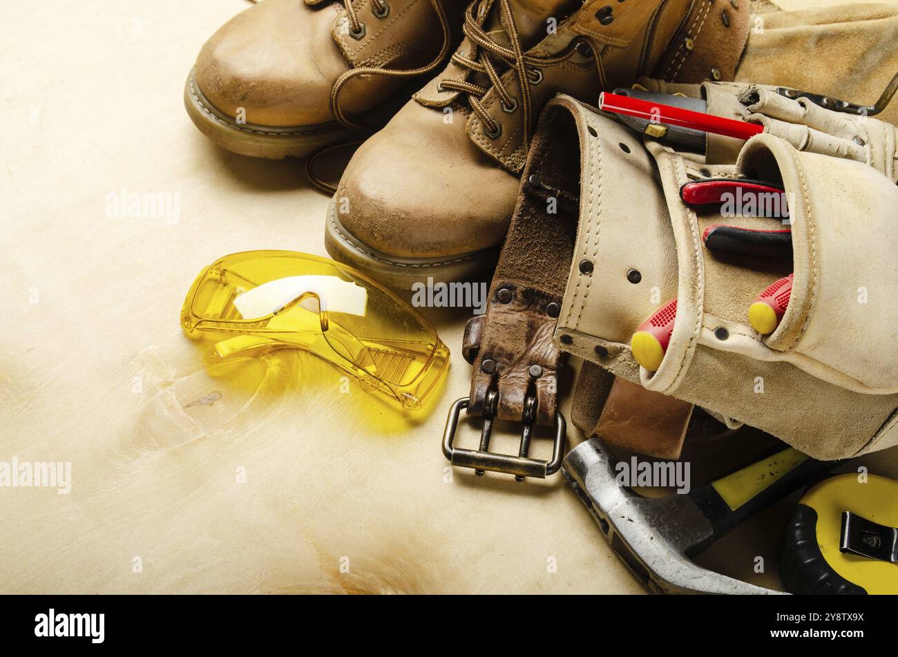 Construction concept background of toolbelt yellow boots goggles ant ...