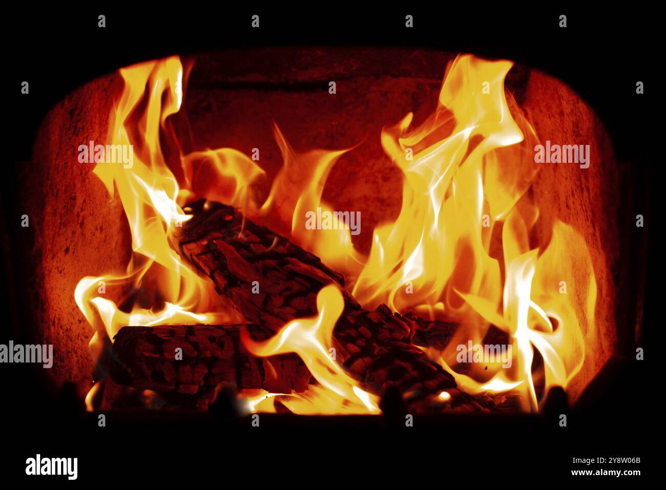 Flame of Wooden logs being burn inside stove Stock Photo - Alamy