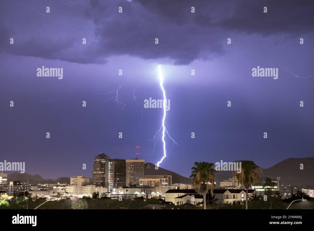 Purple Blue light illuminates the sky over the buildings homes and ...