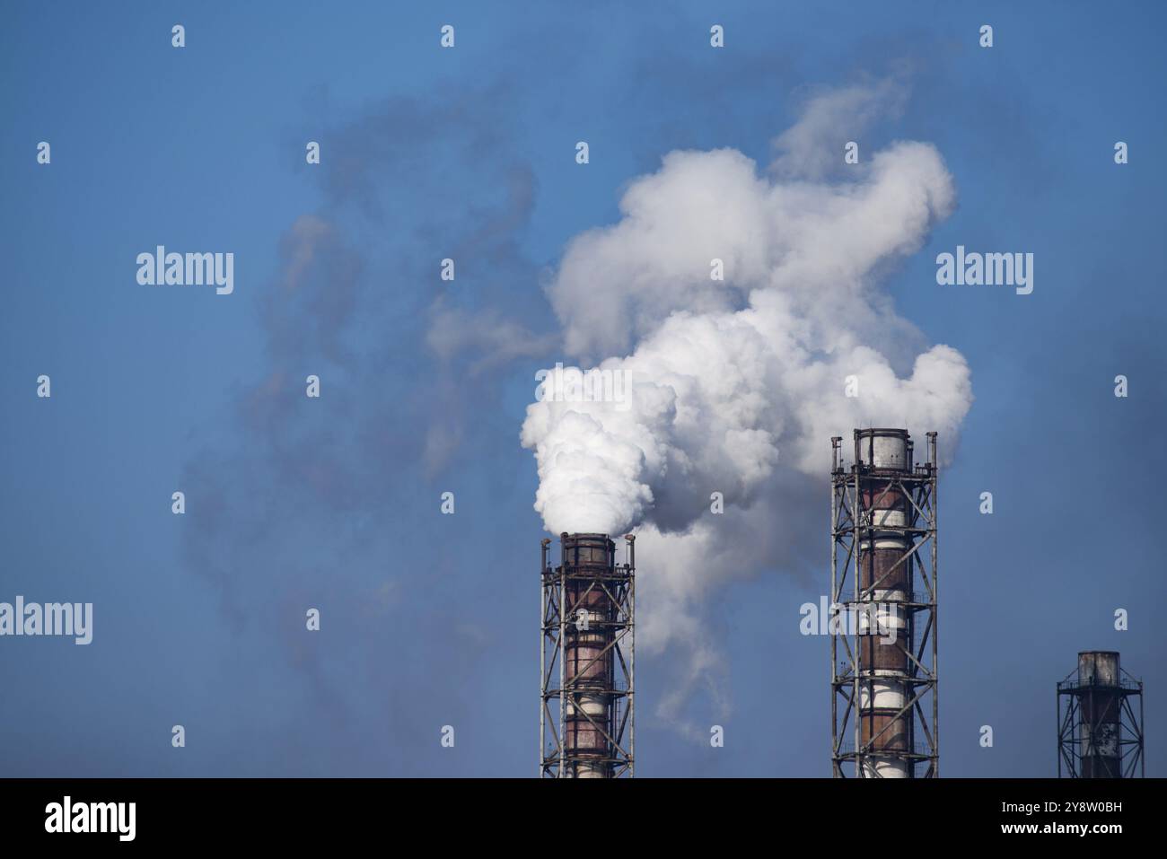 Smoke stack of coal power plant on blue sky background Stock Photo - Alamy