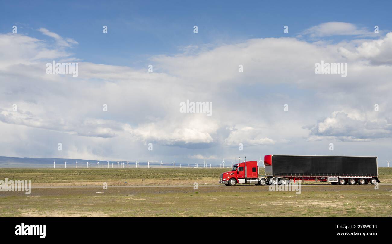 Red big rig semit truck with black cargo trailer on a Utah Highway ...