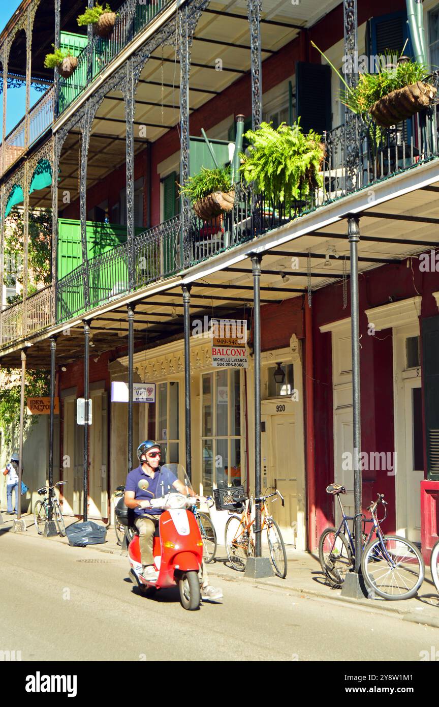 An adult man rides his Vespa scooter through the historic streets of ...