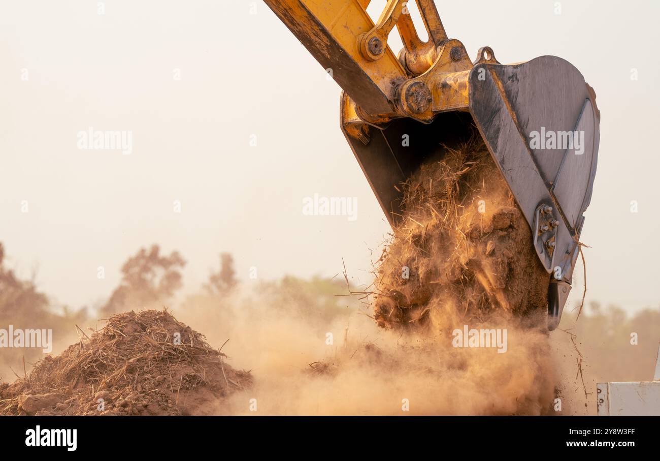 Backhoe working by digging soil at construction site bucket of crawler ...