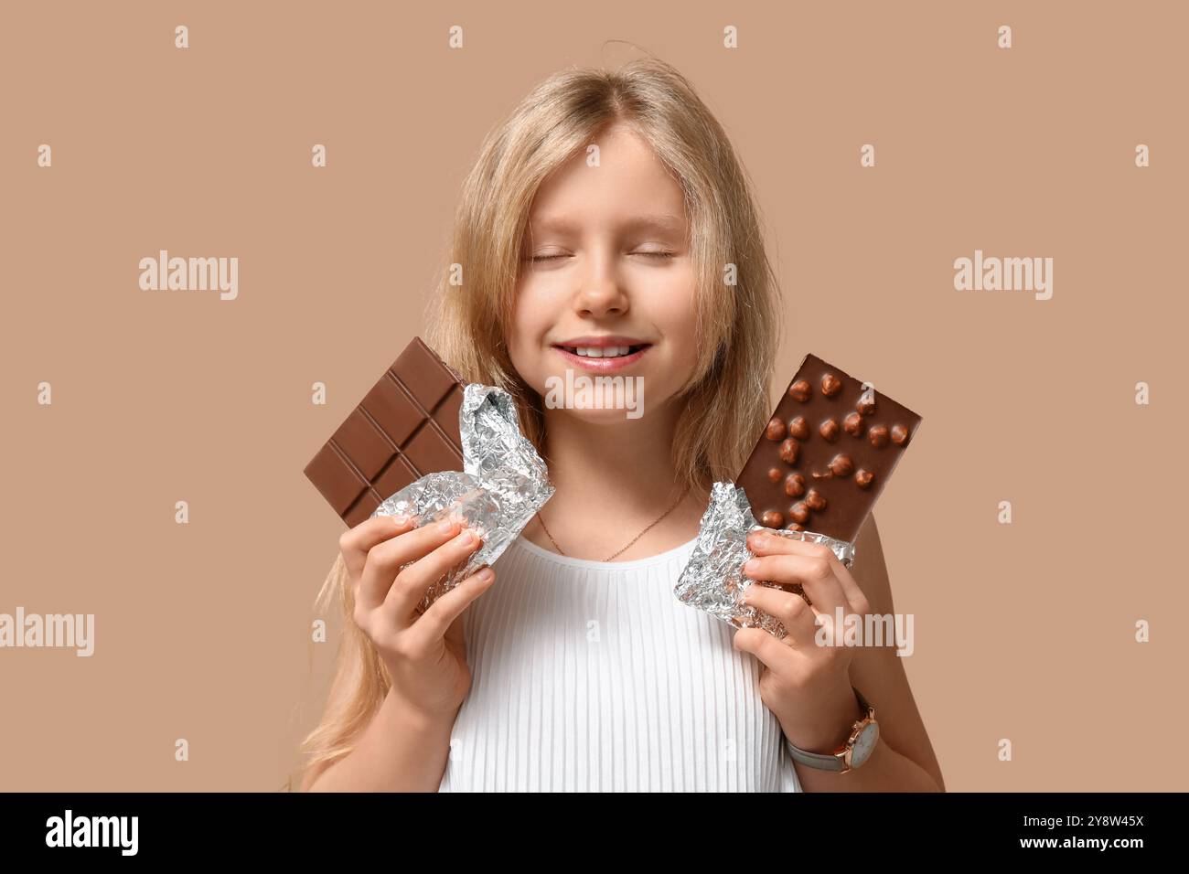 Cute little girl with sweet chocolate bars on brown background Stock ...