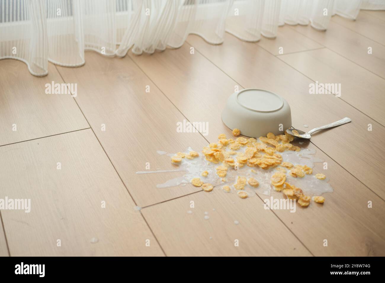 Spilled breakfast cereal on floor Stock Photo - Alamy