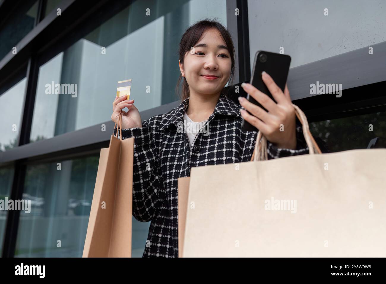 Tech Savvy Shopper Using Phone and Card for Black Friday Deals Stock ...