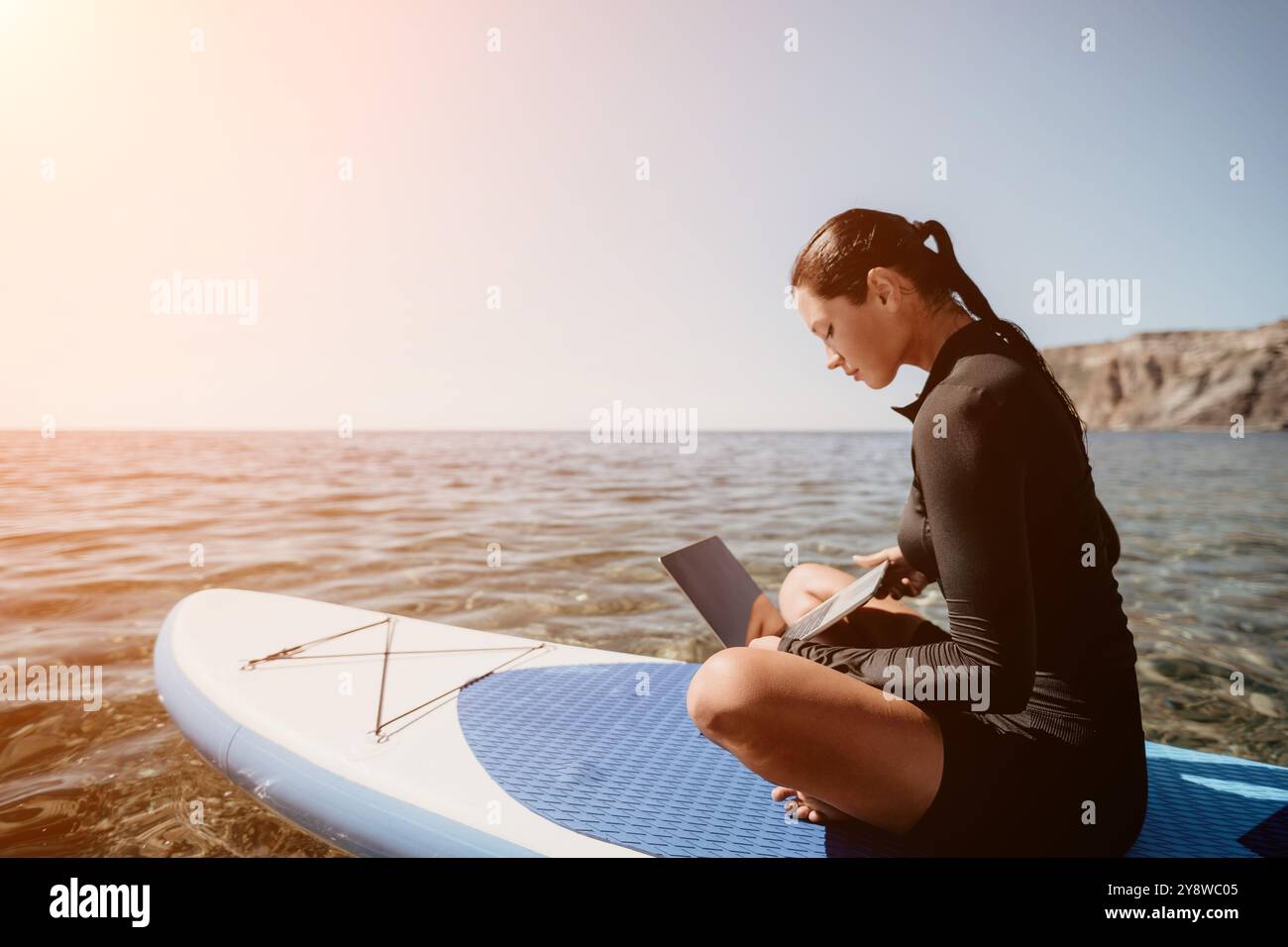 Woman Laptop Paddleboard Working Remotely on Ocean Stock Photo - Alamy