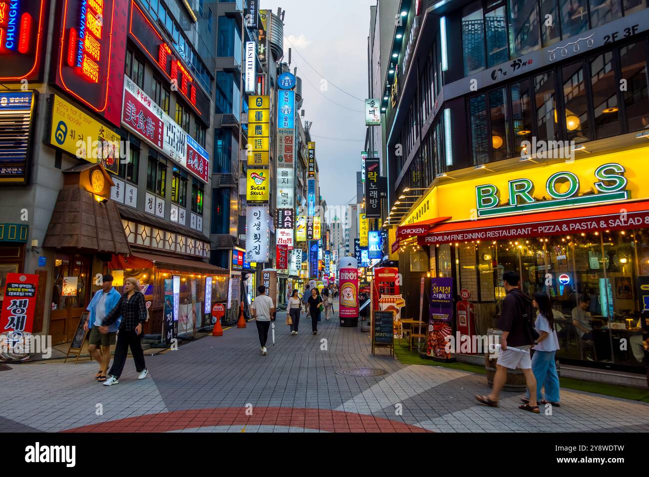street photography of shops and people in the area of Myeong-dong in in ...