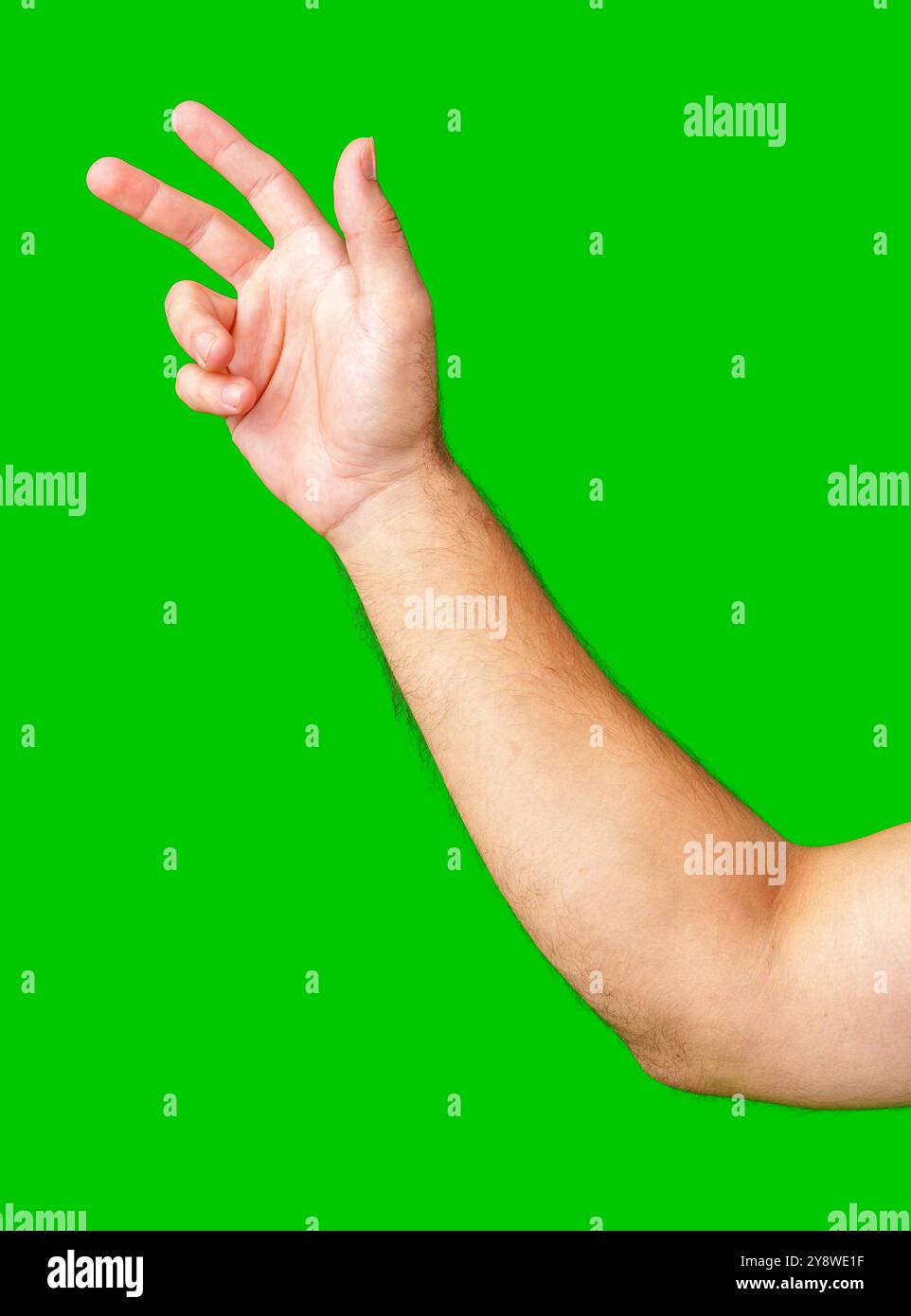human arm gesturing with raised fingers against a bright green backdrop ...
