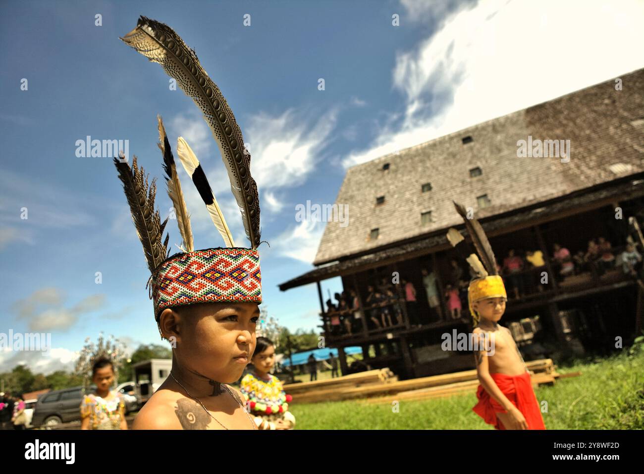 Children in traditional attires standing in lines for a welcome ...