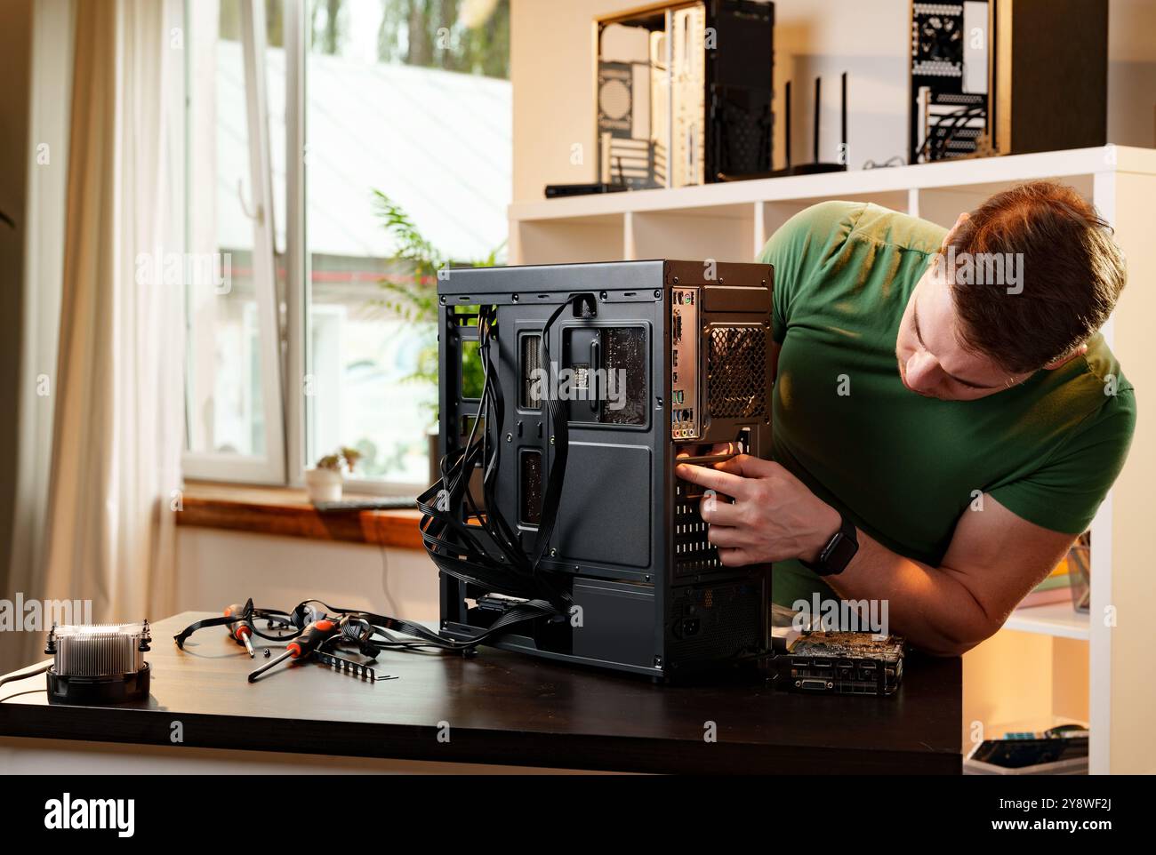 Man assembles a computer system unit at home Stock Photo - Alamy