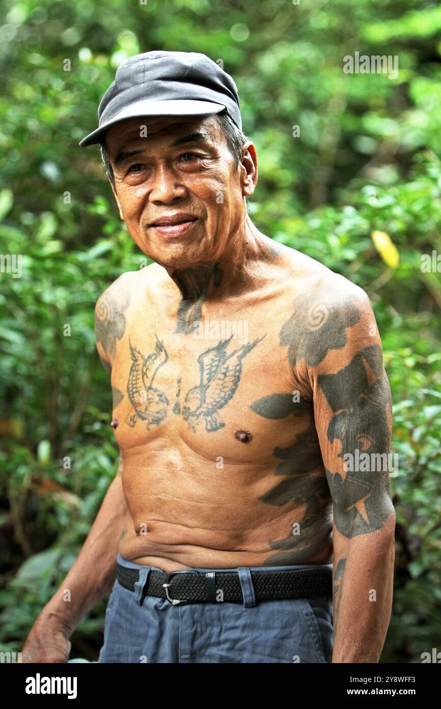 Portrait of Ramping, a member of the traditional Dayak Iban longhouse ...