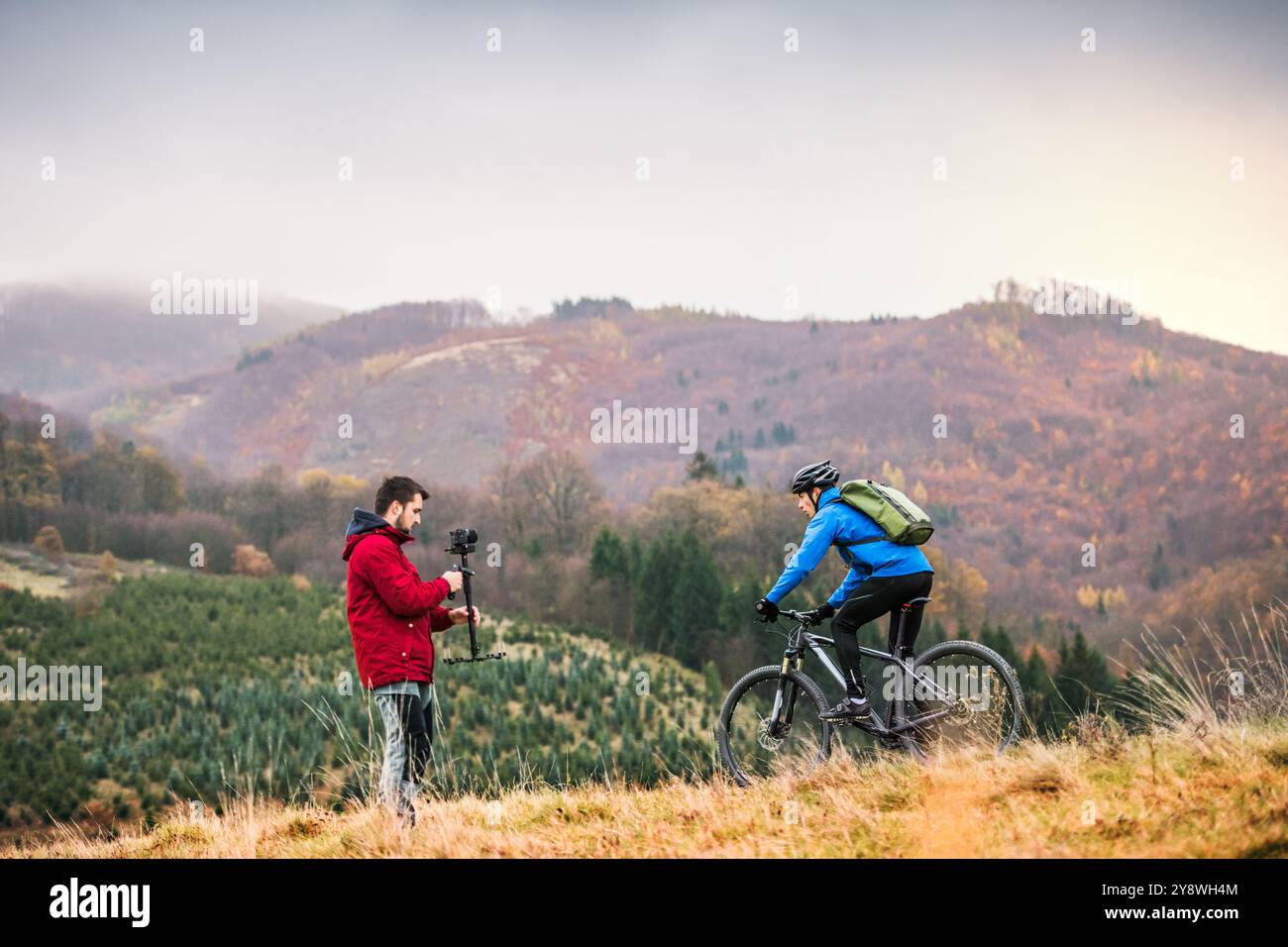 Cyclist is filming video, riding in nature and cameraman with a camera ...