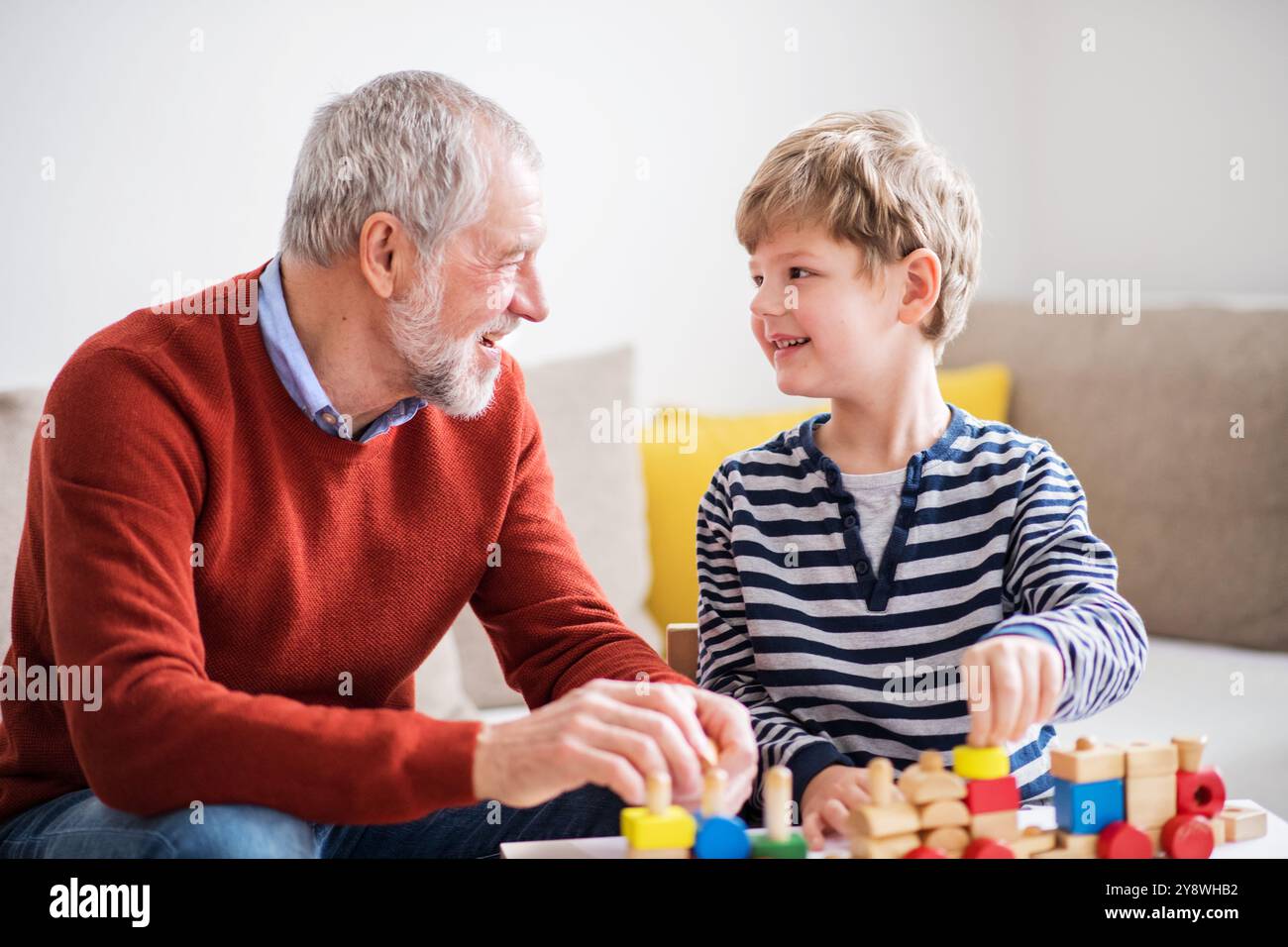 Grandfather spending time with grandson, taking care of him while ...