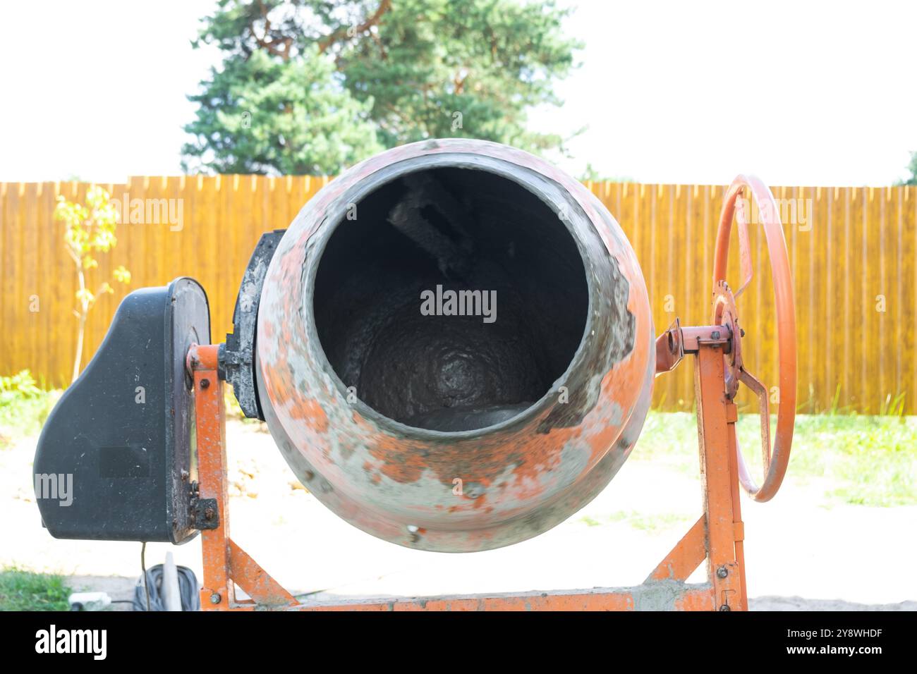 Mixing mortar in a handheld portable concrete mixer Stock Photo - Alamy
